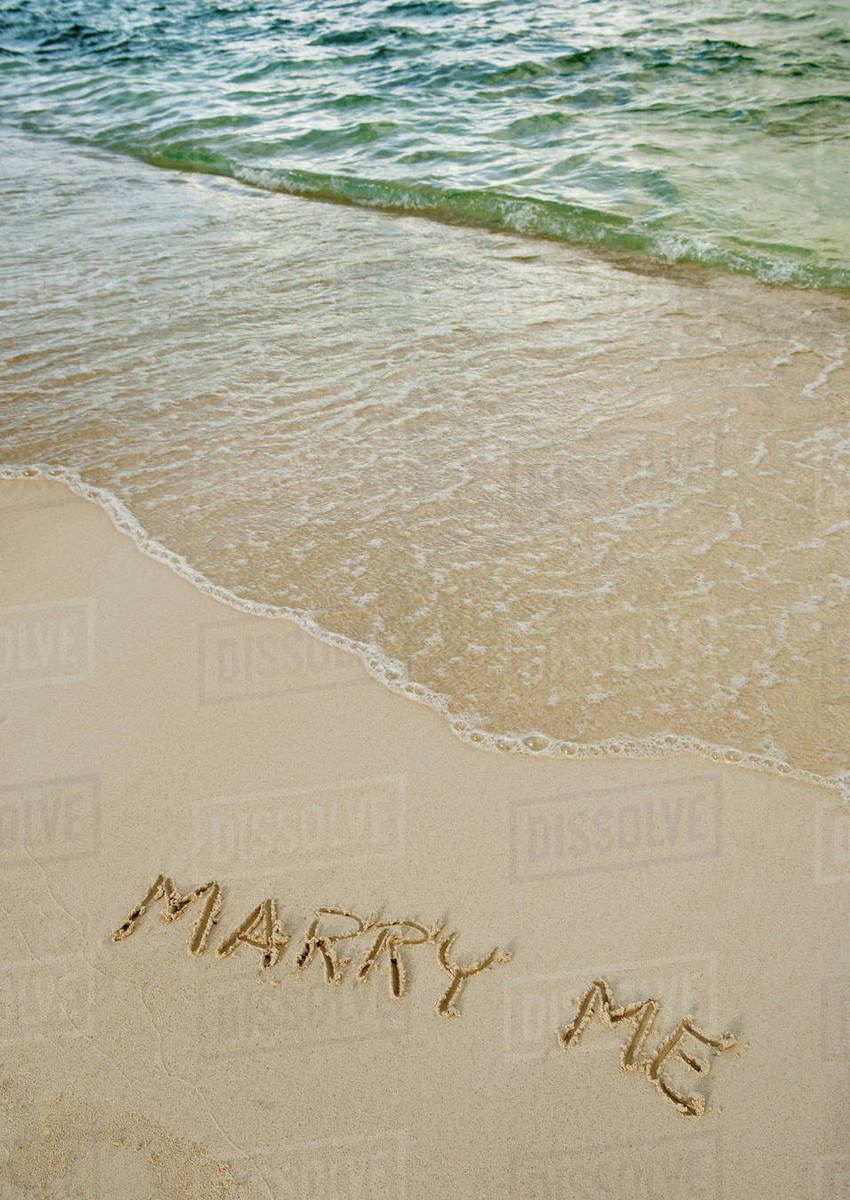 Marry me message written in sand - Royalty-free Stock Photo | Dissolve