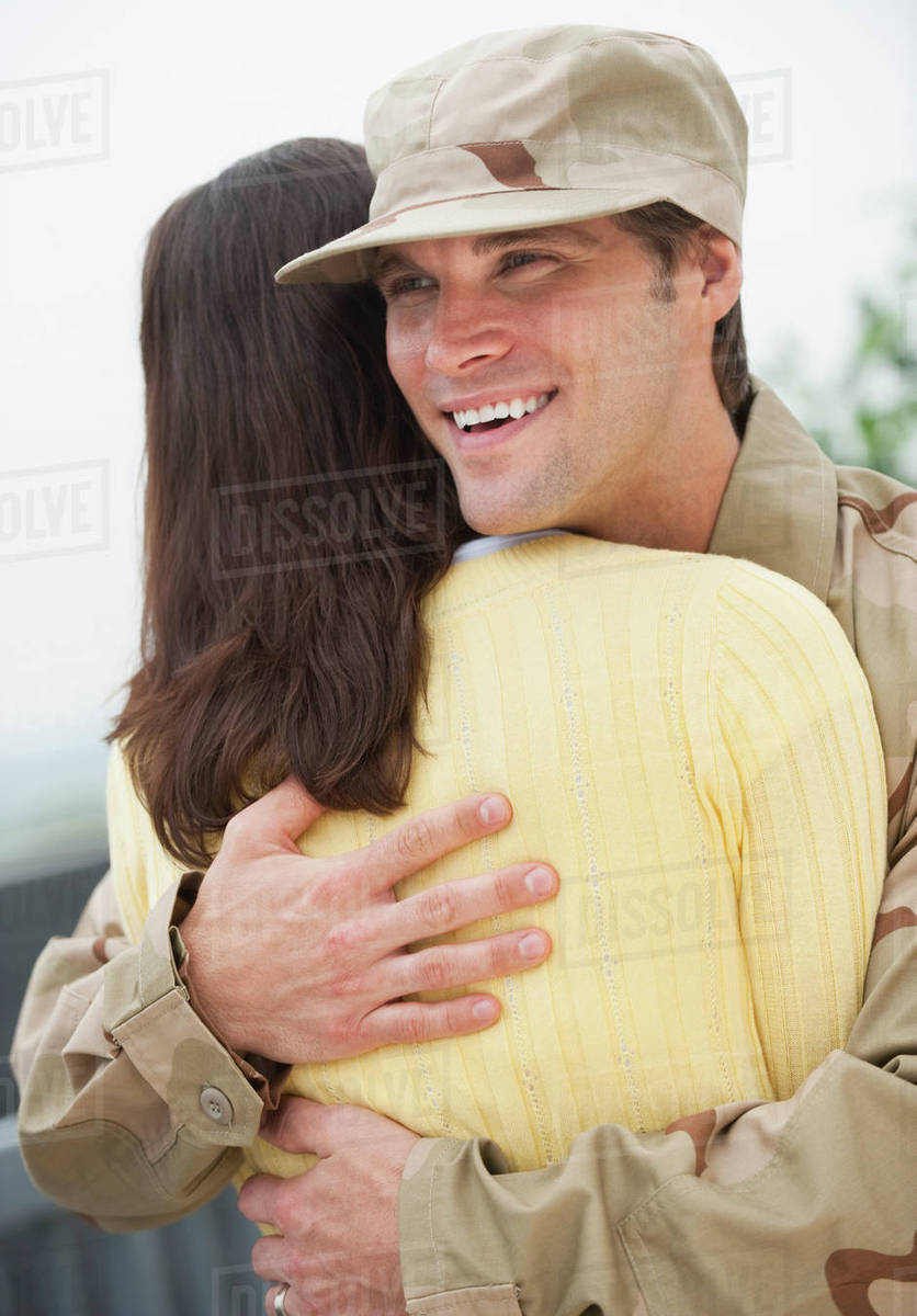 A woman hugging a military officer - Royalty-free Stock Photo | Dissolve