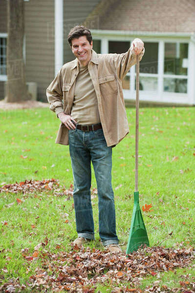 Man raking leaves - Stock Photo - Dissolve