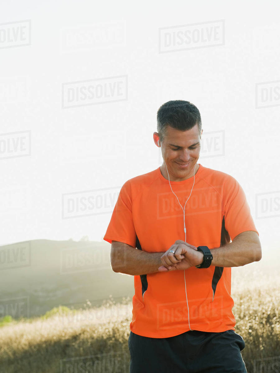 Man looking at watch - Royalty-free Stock Photo | Dissolve