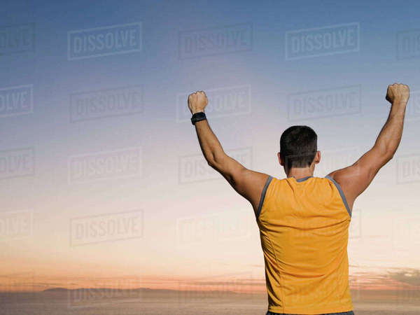 Man raising arms - Stock Photo - Dissolve
