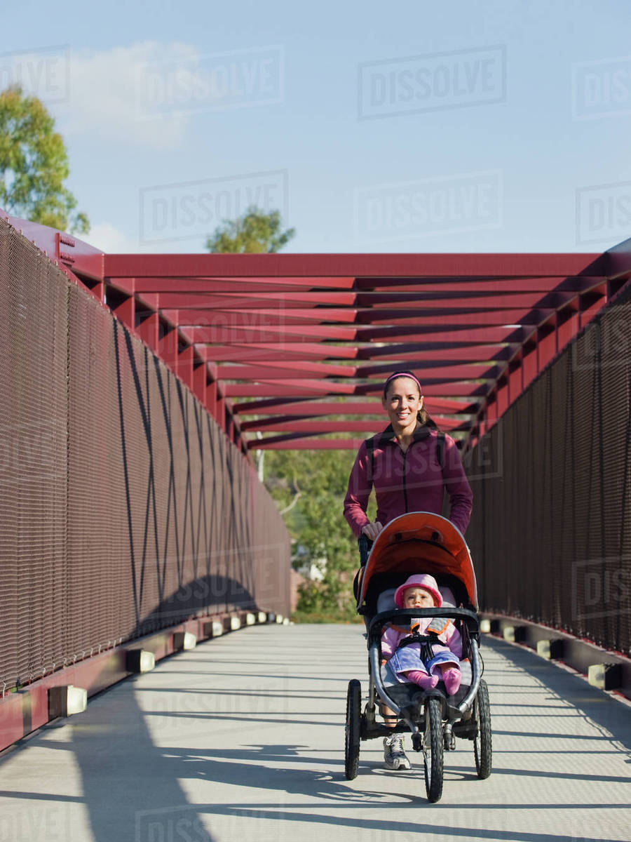 Woman pushing stroller - Stock Photo - Dissolve