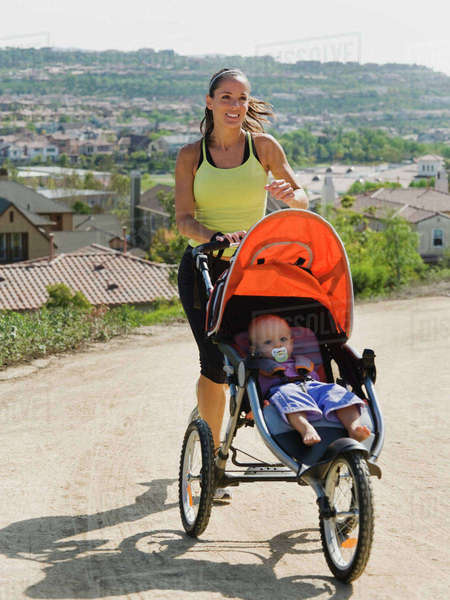 Woman jogging with stroller - Royalty-free Stock Photo | Dissolve