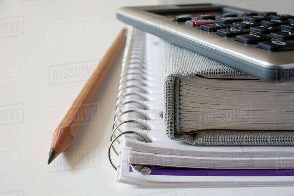 Calculator, textbook and pencil on notebook, studio shot - Royalty-free ...