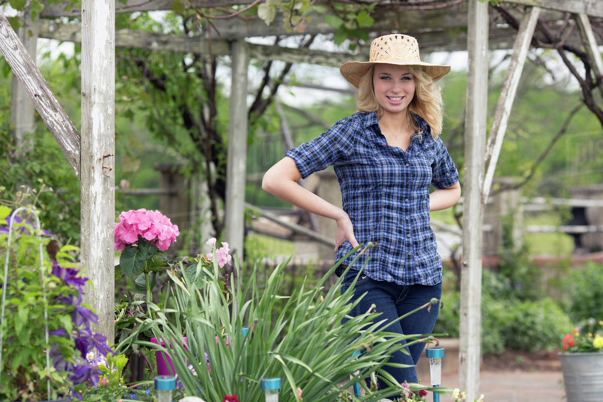 Portrait of young woman in garden - Royalty-free Stock Photo | Dissolve