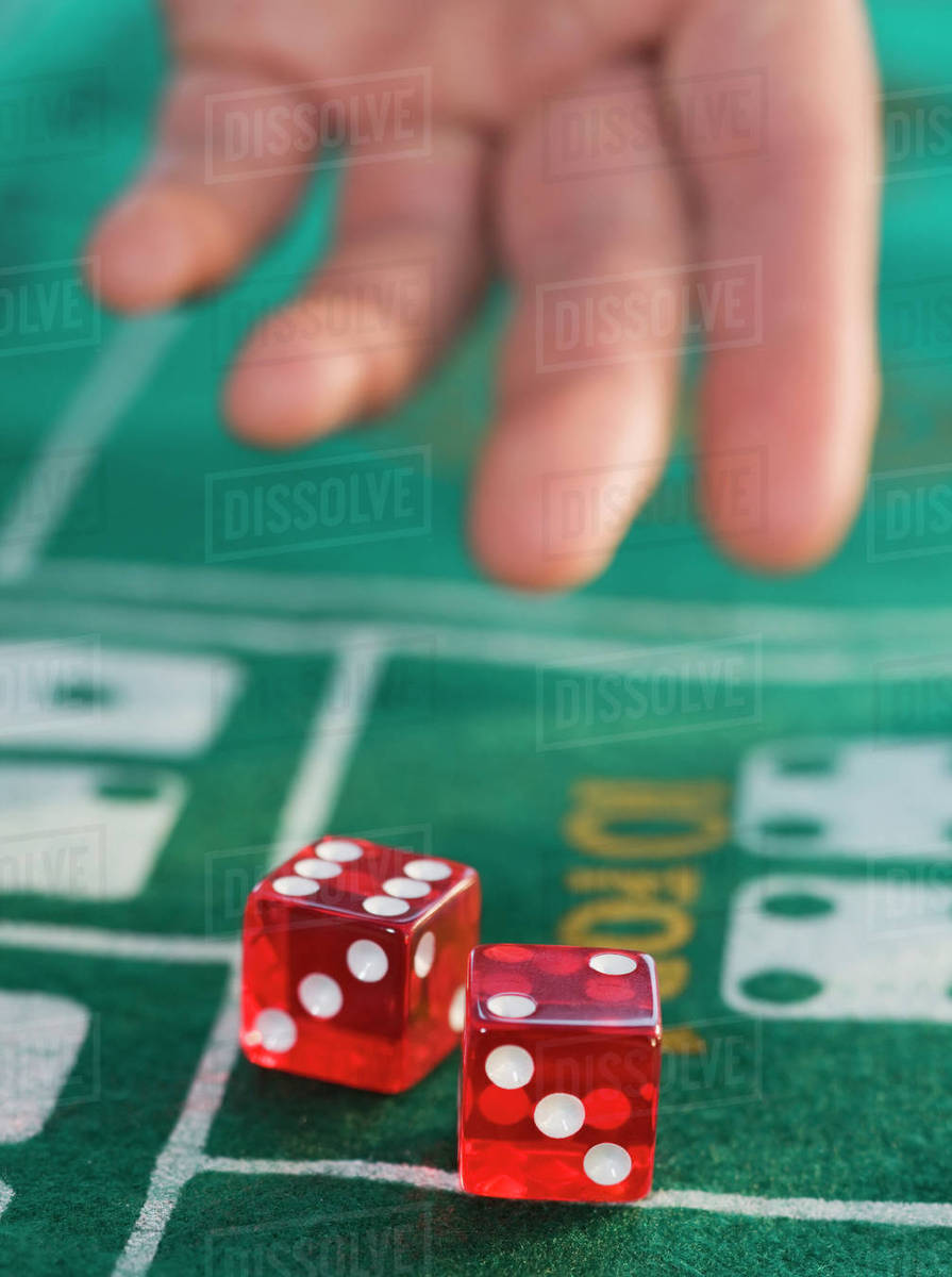 Close up of man throwing dice - Royalty-free Stock Photo | Dissolve