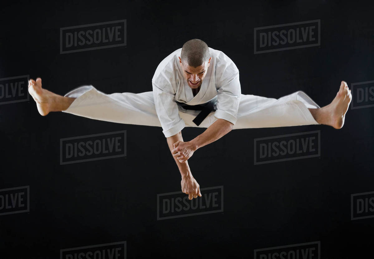 Hispanic male karate black belt jumping in air - Royalty-free Stock ...