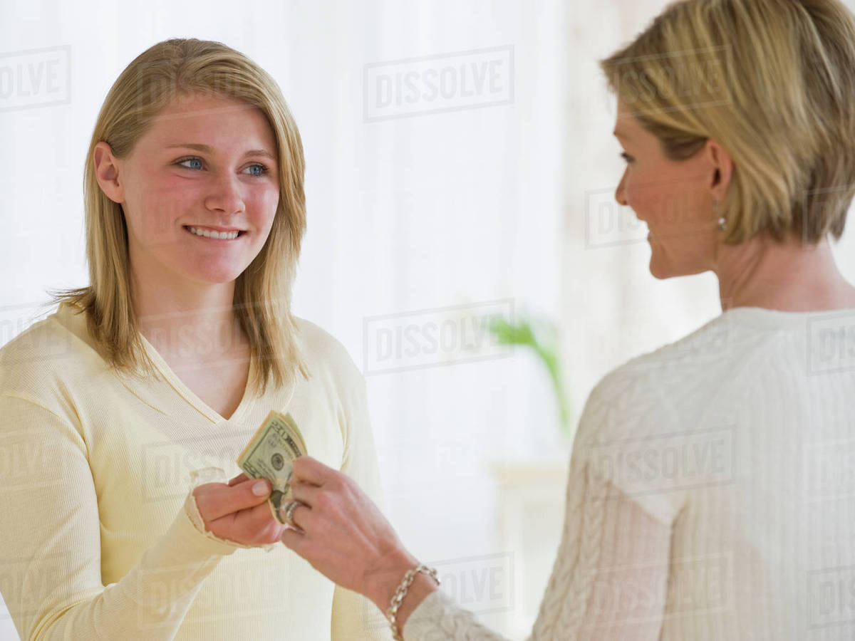 Mother giving money to teenaged daughter - Royalty-free Stock Photo ...