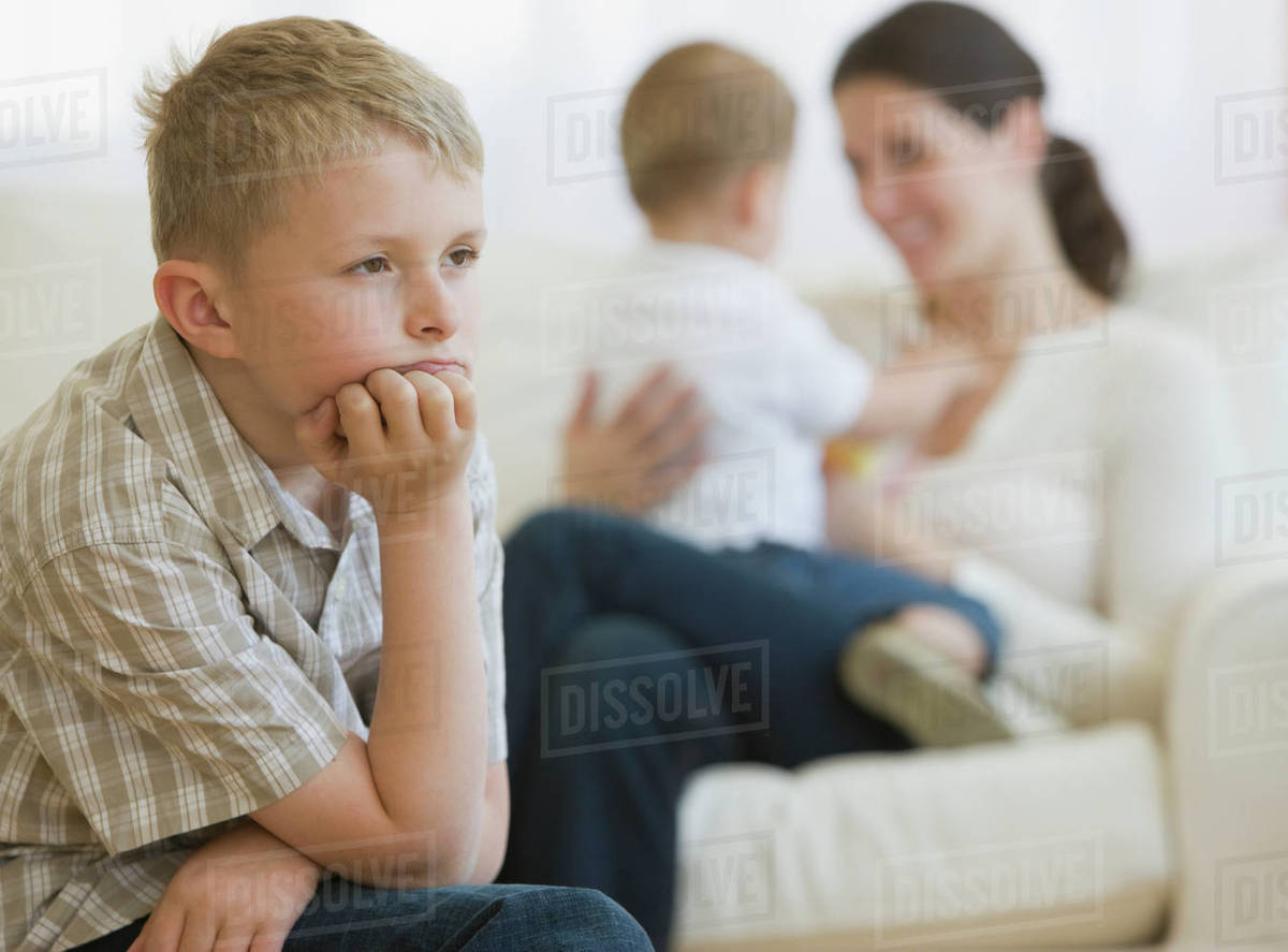 Boy thinking in front of mother and baby - Royalty-free Stock Photo ...