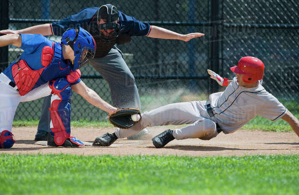 Baseball player sliding into home plate - Royalty-free Stock Photo ...