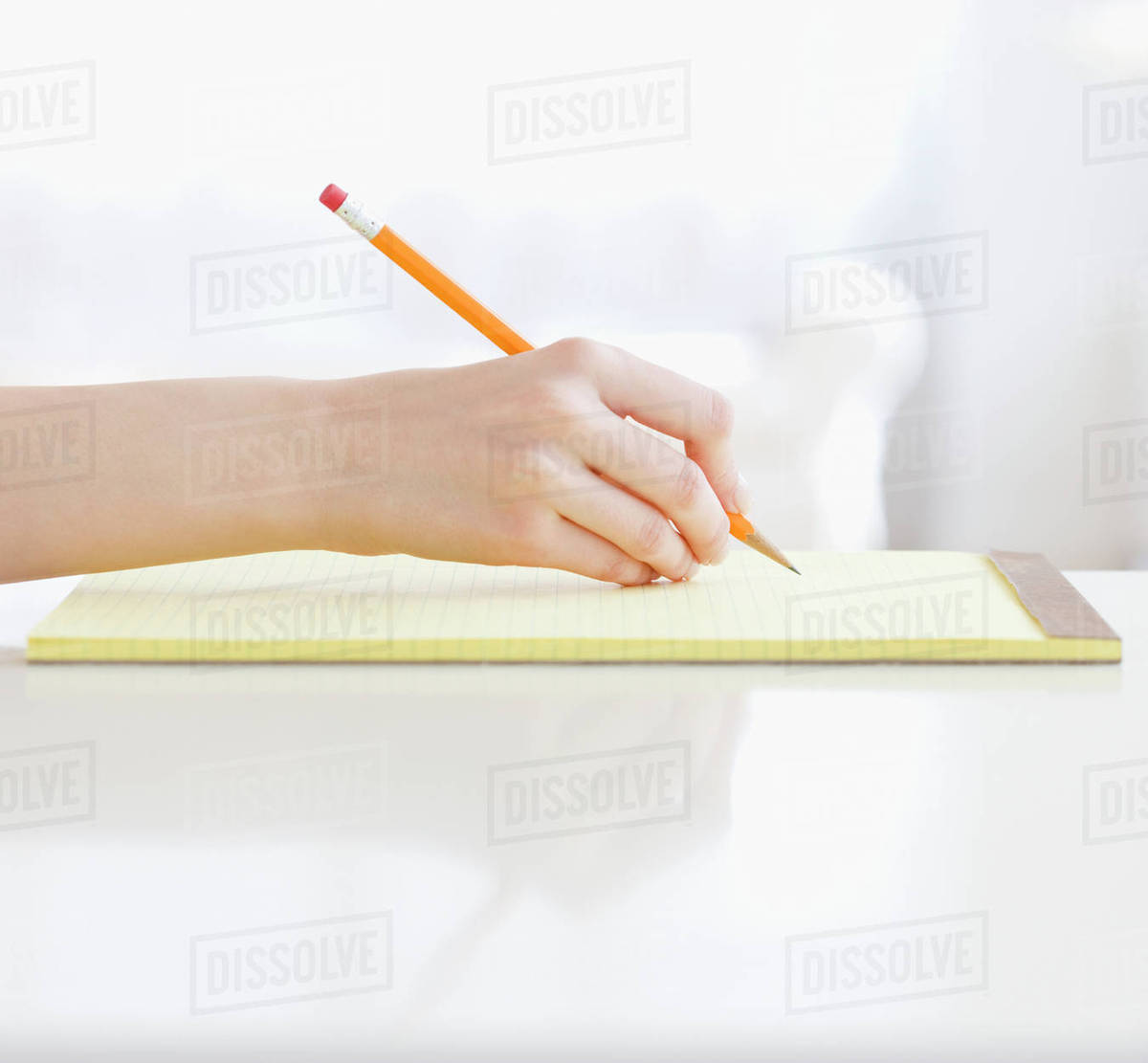 Woman writing on notepad - Royalty-free Stock Photo | Dissolve