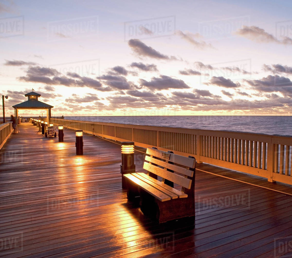 Benches on pier during sunrise/sunset - Royalty-free Stock Photo | Dissolve