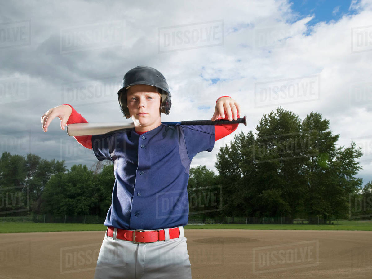 Baseball player posing with bat - Royalty-free Stock Photo | Dissolve