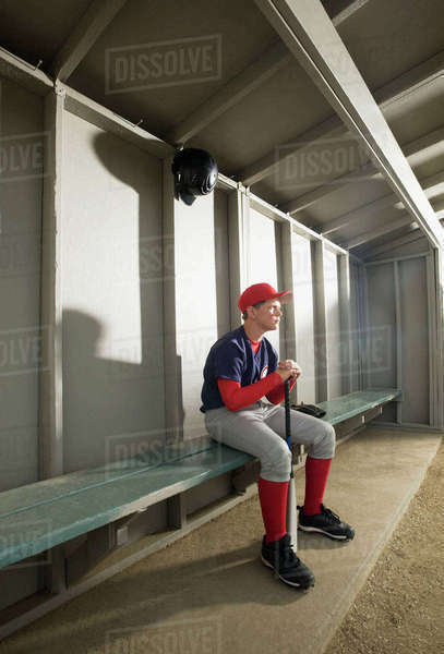Serious baseball player sitting in dugout - Royalty-free Stock Photo ...
