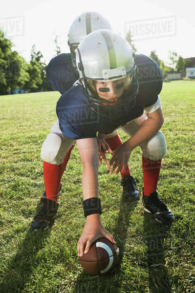 Football center preparing to snap football - Royalty-free Stock Photo ...