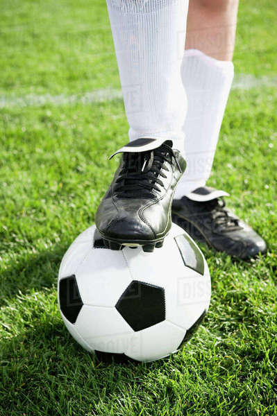 Close up of boy’s foot on soccer ball - Royalty-free Stock Photo | Dissolve