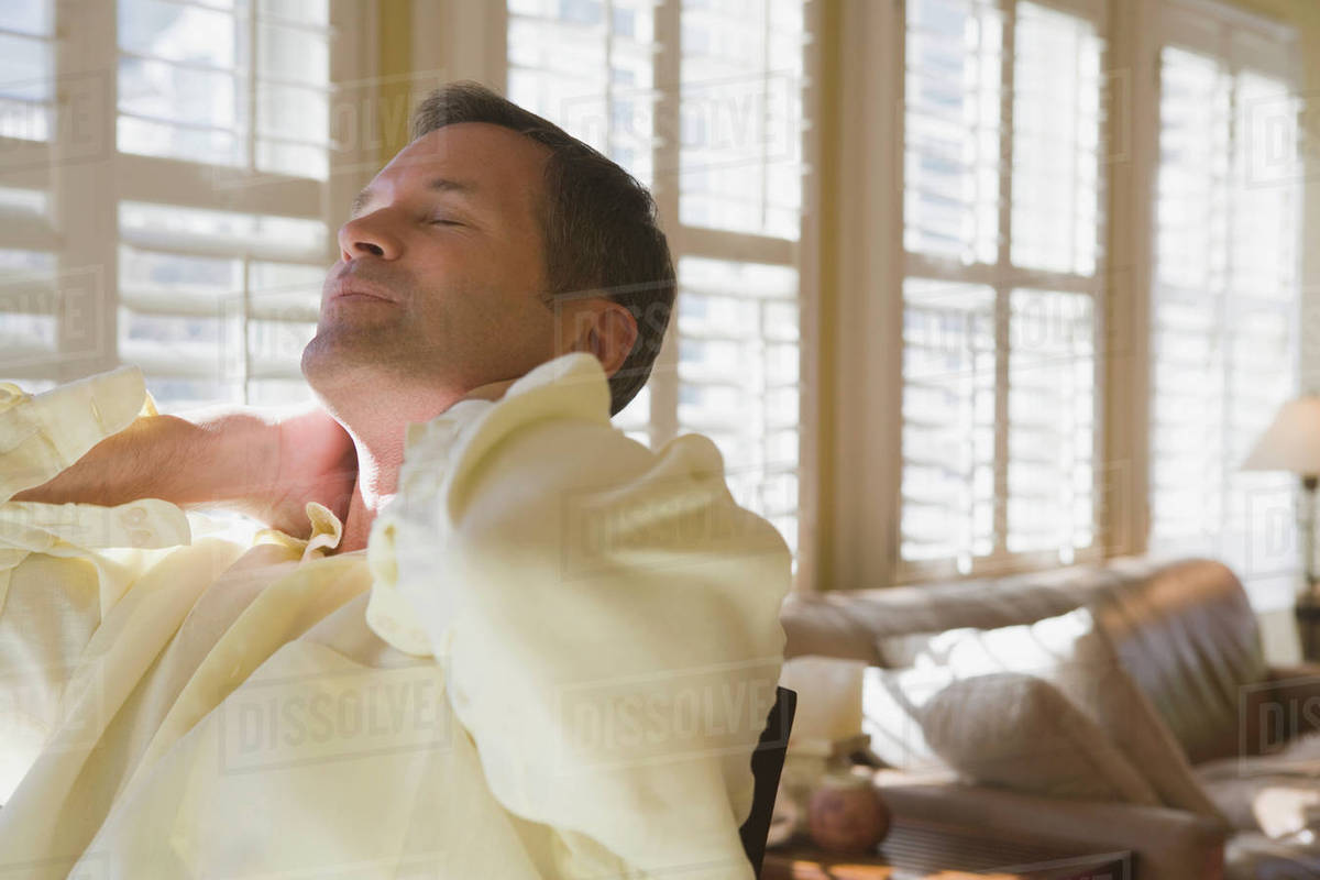 Man relaxing in livingroom - Royalty-free Stock Photo | Dissolve