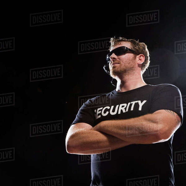 Security guard standing with arms crossed - Royalty-free Stock Photo ...