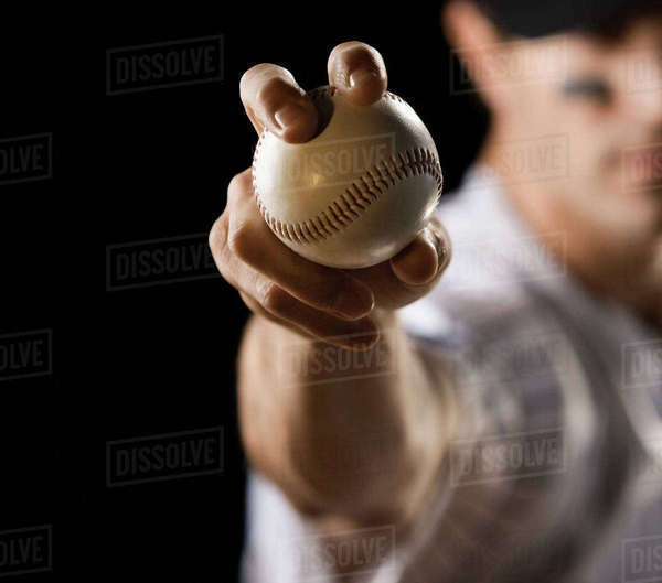 Close up of pitcher holding baseball - Royalty-free Stock Photo | Dissolve