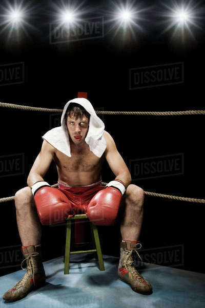 Boxer sitting on stool in corner of boxing ring - Royalty-free Stock ...
