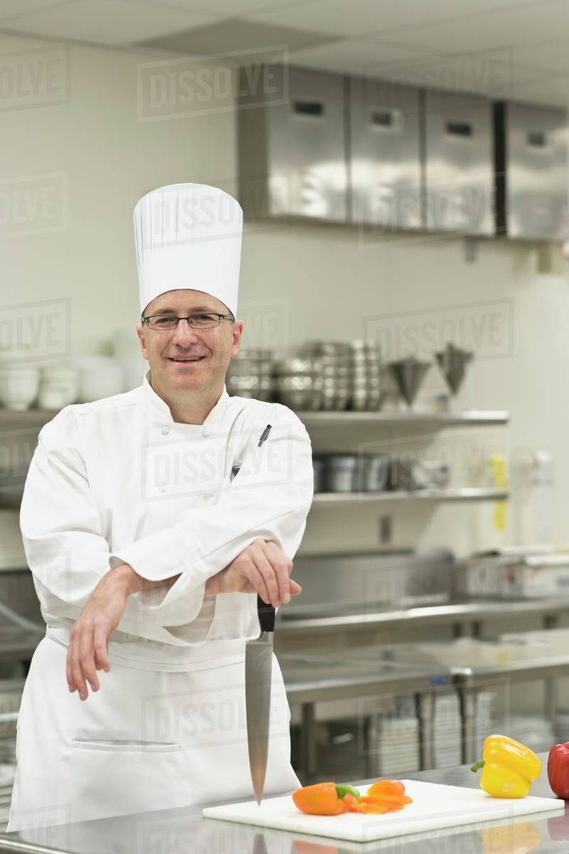 Chef posing in kitchen - Royalty-free Stock Photo | Dissolve