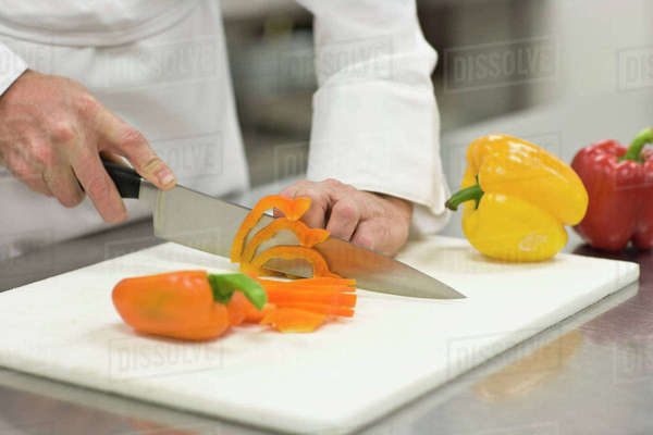 Chef chopping bell peppers - Royalty-free Stock Photo | Dissolve