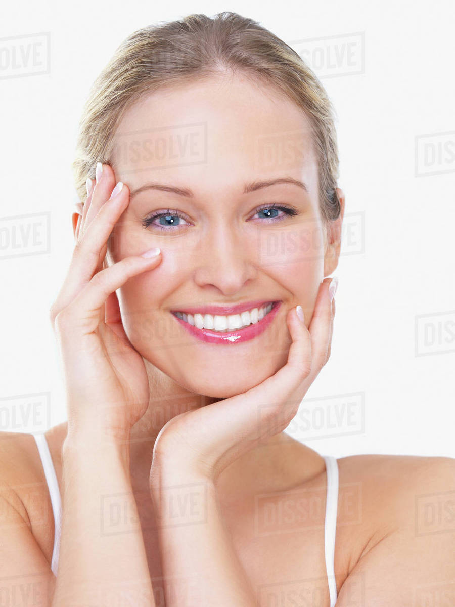 Woman with hands on face - Stock Photo - Dissolve
