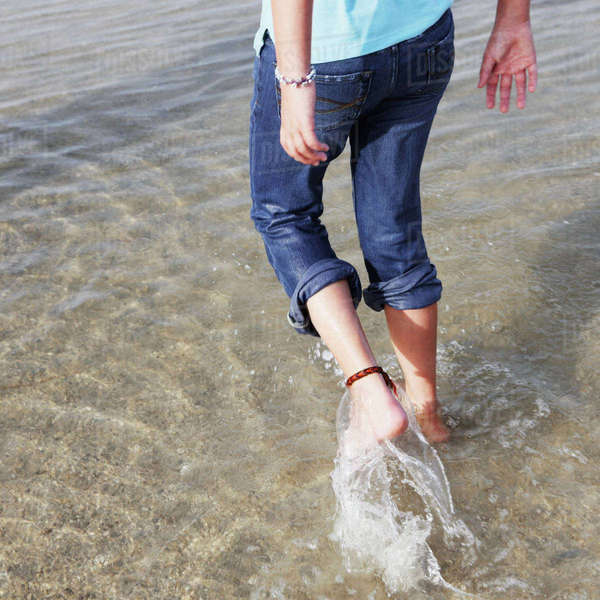 Girl wading in ocean - Royalty-free Stock Photo | Dissolve