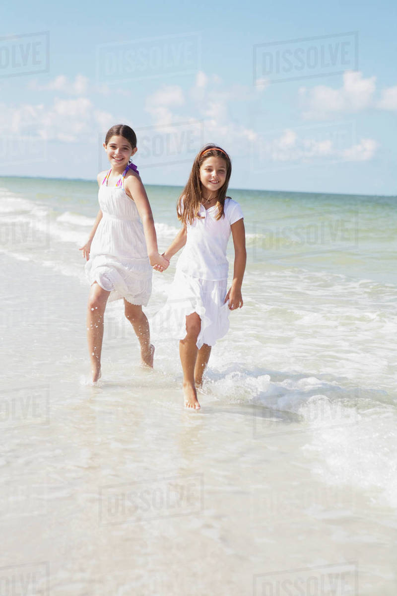 Girls running in ocean - Royalty-free Stock Photo | Dissolve