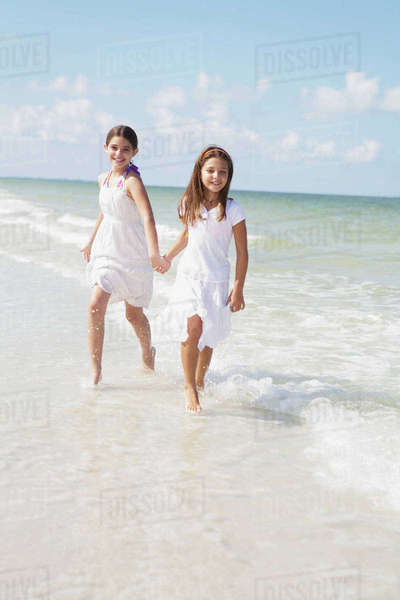 Girls running in ocean - Royalty-free Stock Photo | Dissolve