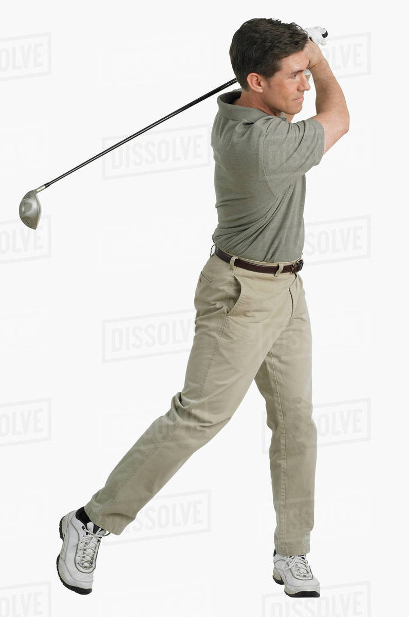Studio shot of man playing golf - Royalty-free Stock Photo | Dissolve