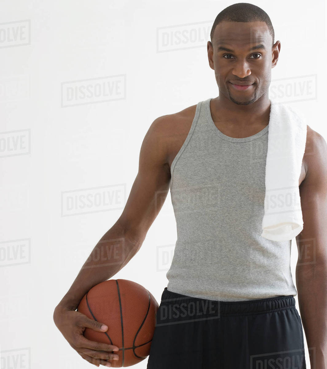 Portrait of man holding basketball - Royalty-free Stock Photo | Dissolve