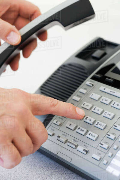 Man dialing telephone - Royalty-free Stock Photo | Dissolve