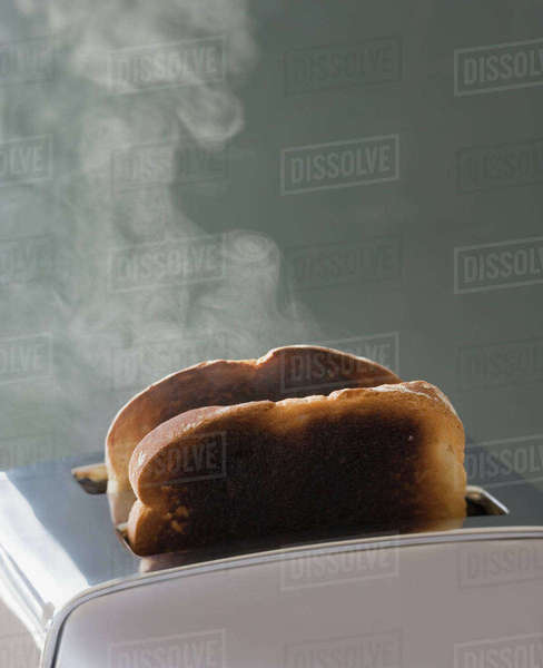 Toast burning in toaster - Royalty-free Stock Photo | Dissolve