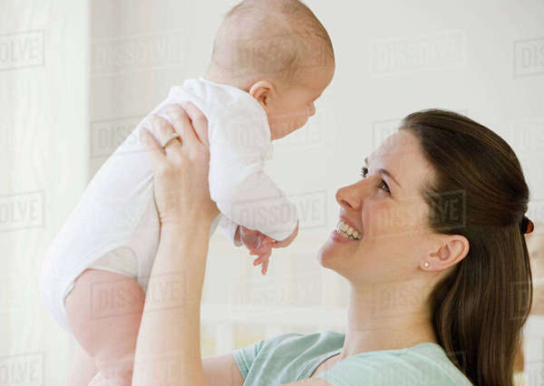 Mother smiling at baby - Stock Photo - Dissolve