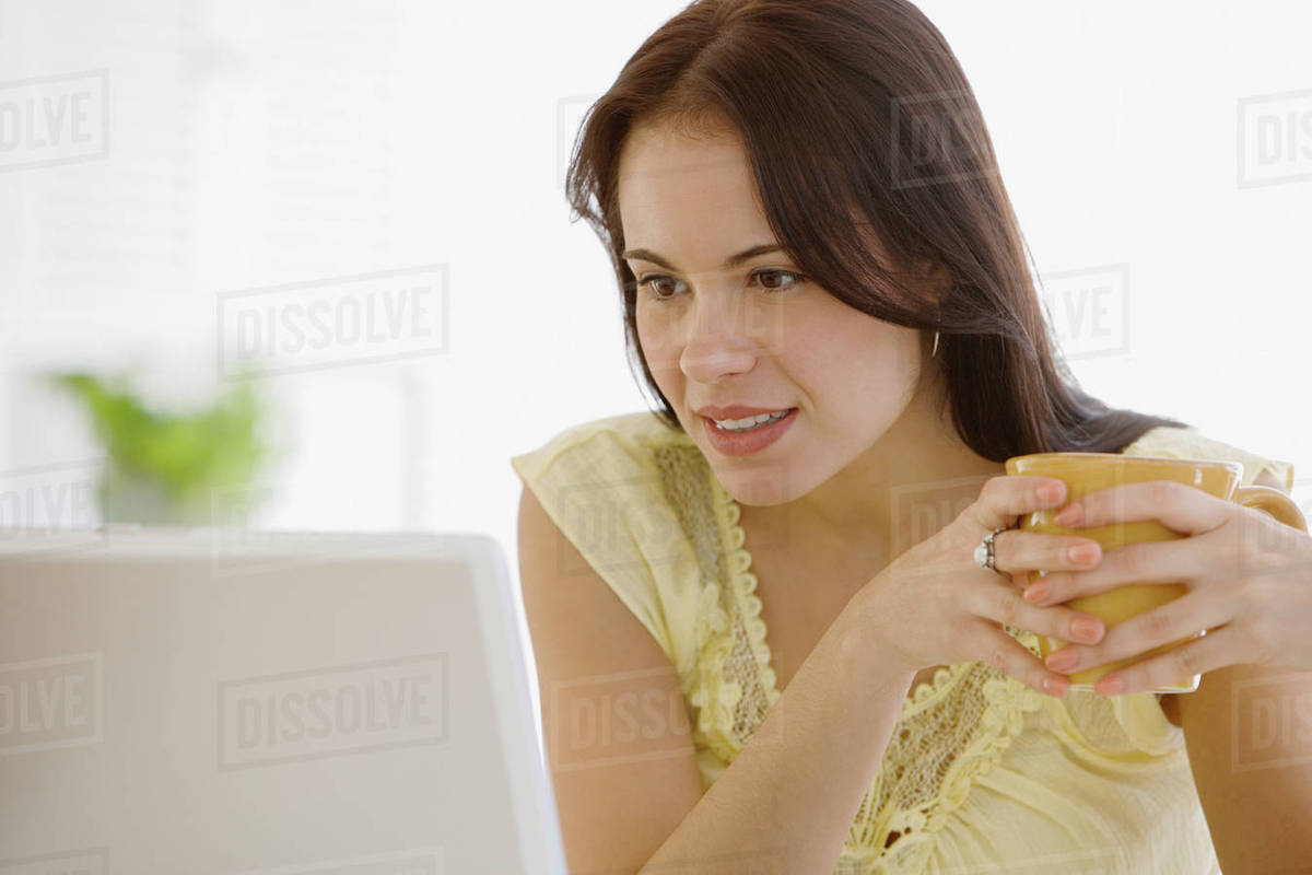 Woman looking at computer - Royalty-free Stock Photo | Dissolve