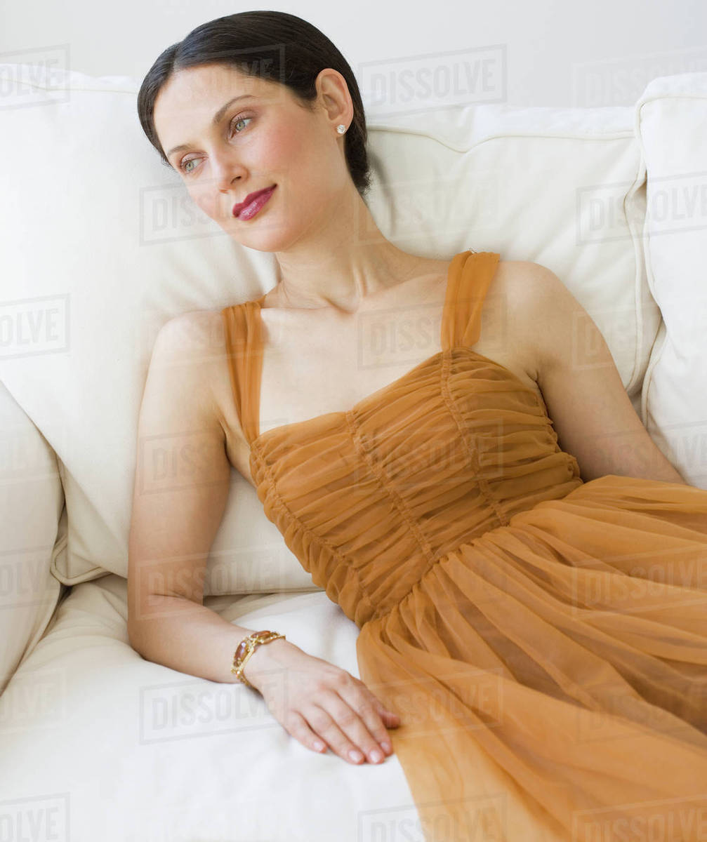 Woman laying on sofa - Stock Photo - Dissolve