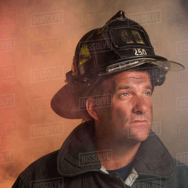 Male firefighter in smoke - Royalty-free Stock Photo | Dissolve