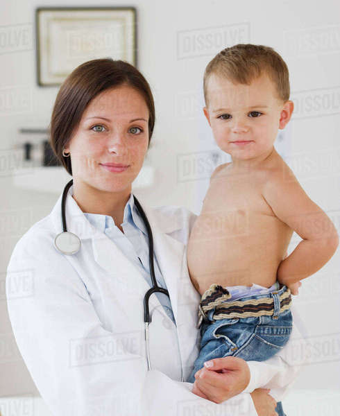 Female doctor holding baby - Royalty-free Stock Photo | Dissolve
