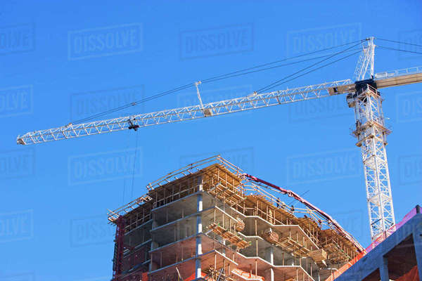 Low angle view of construction site and crane - Royalty-free Stock ...