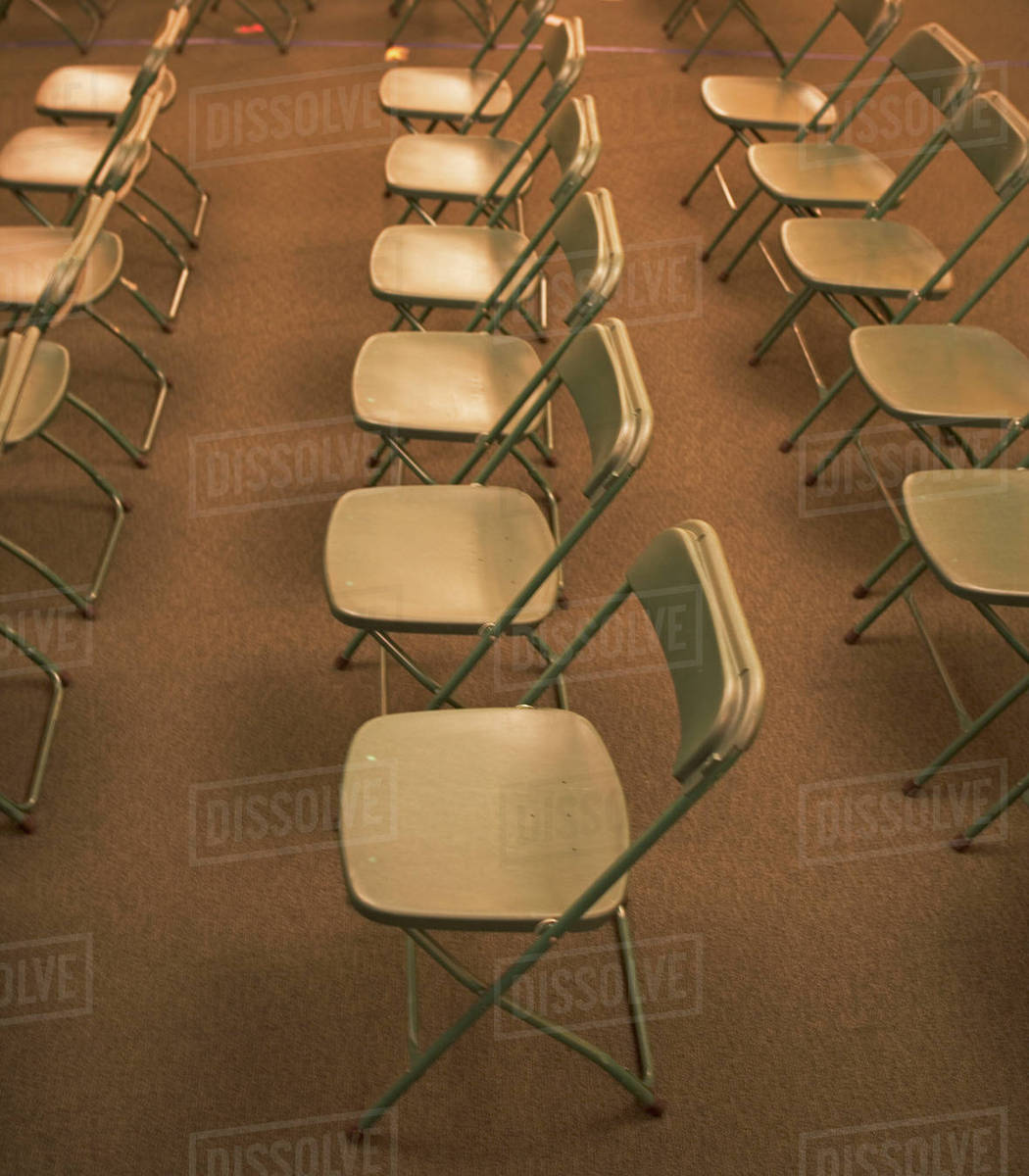 Empty folding chairs in rows - Stock Photo - Dissolve