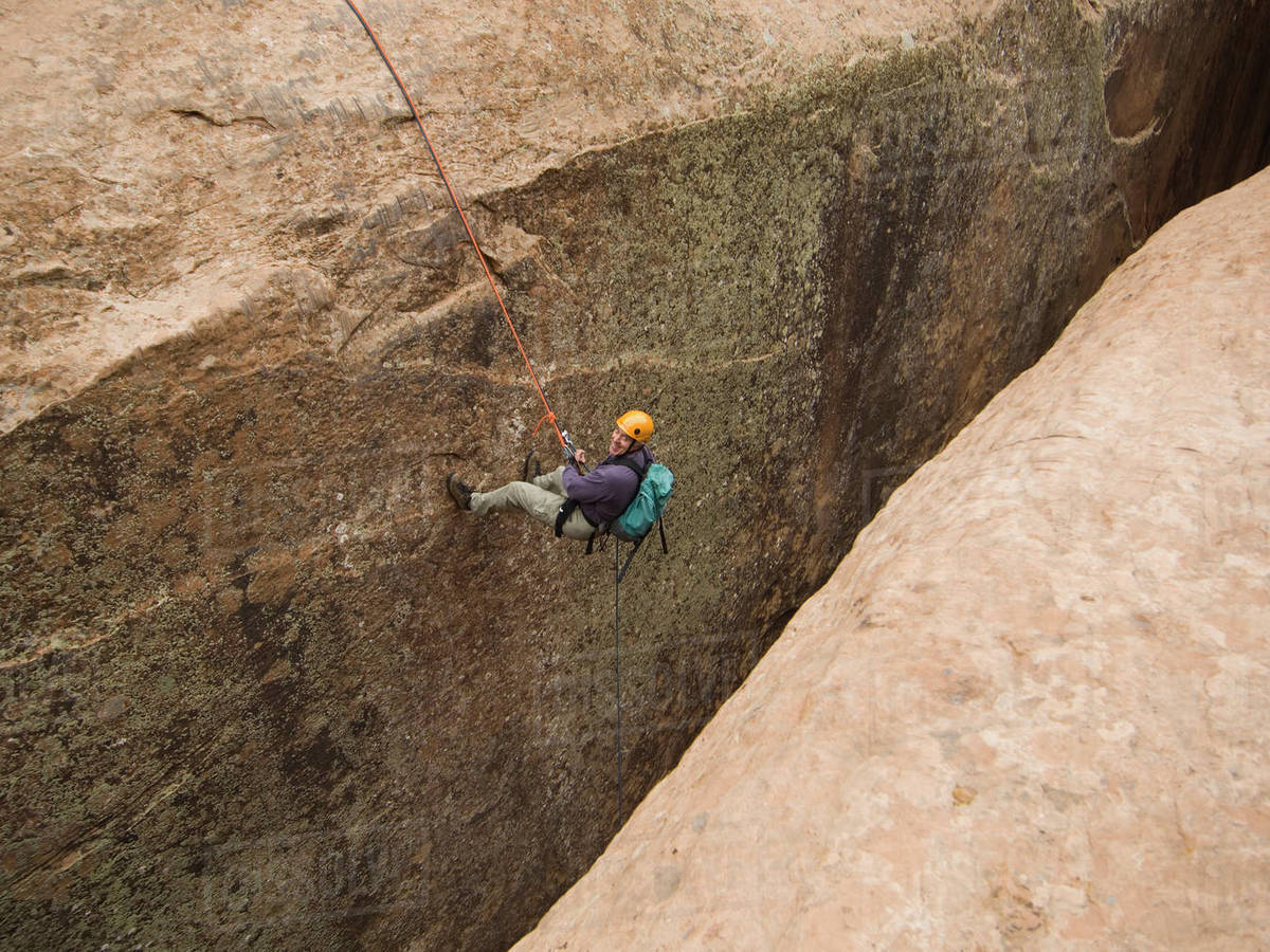 Man canyon rappelling - Royalty-free Stock Photo | Dissolve