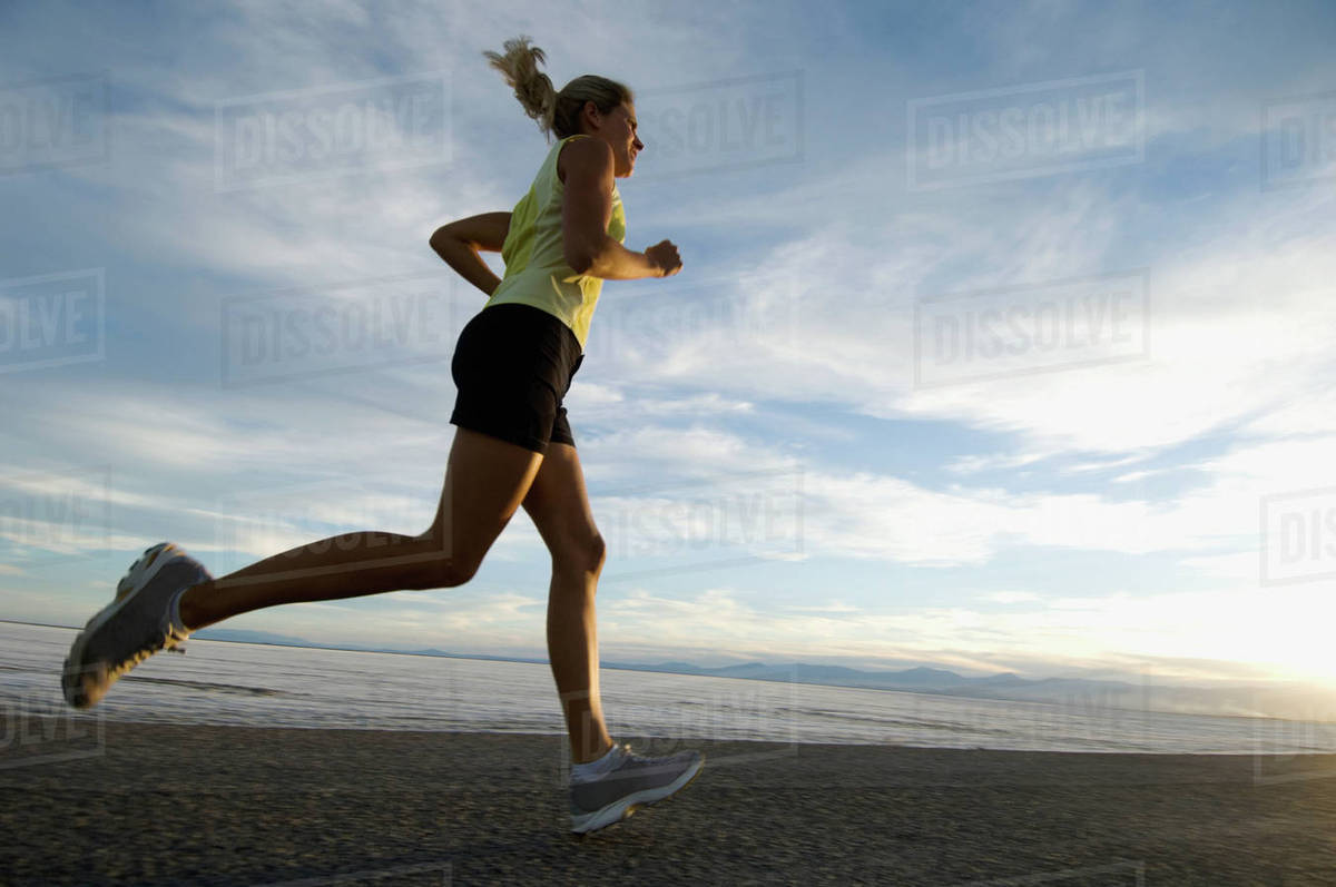 Woman running on road, Utah, United States - Royalty-free Stock Photo ...