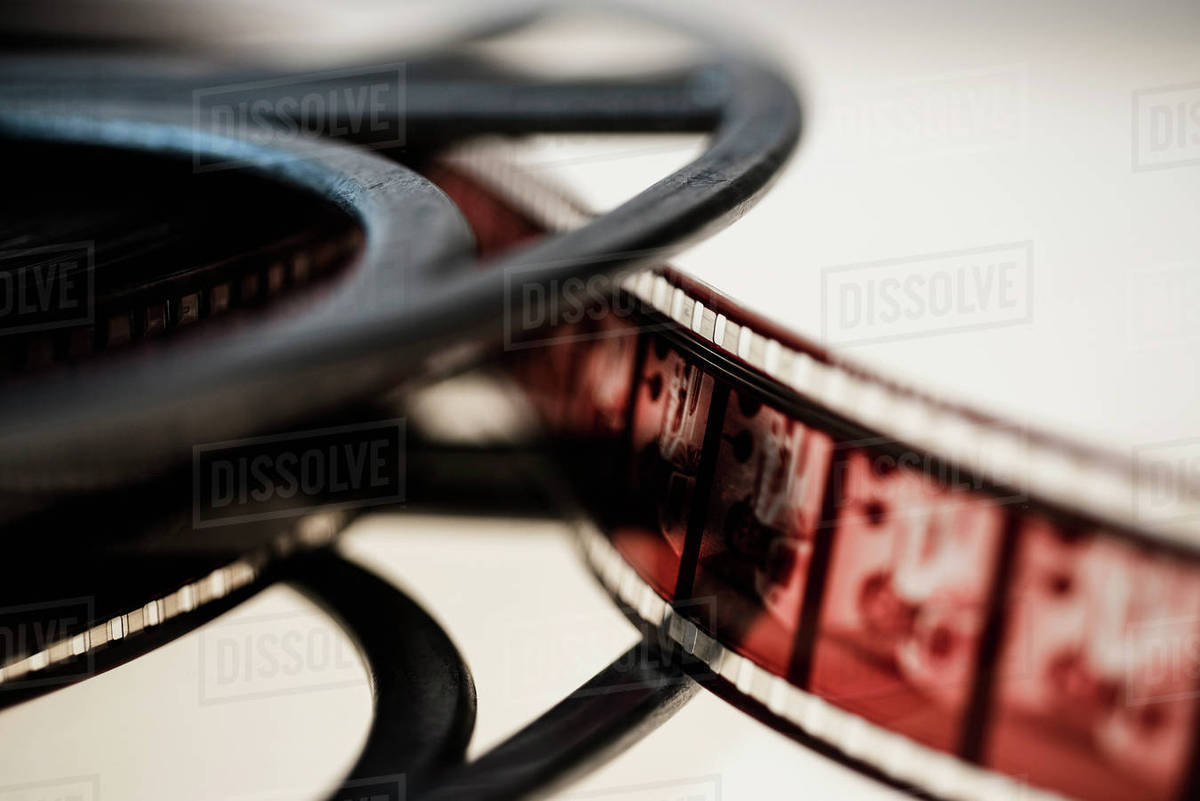 Close-up of film reel on white background - Stock Photo - Dissolve