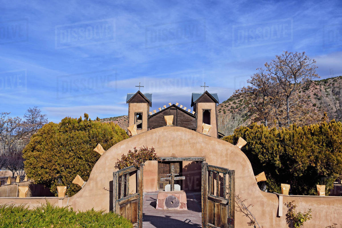 USA, New Mexico, Chimayo, El Santuario de Chimayo among trees and ...