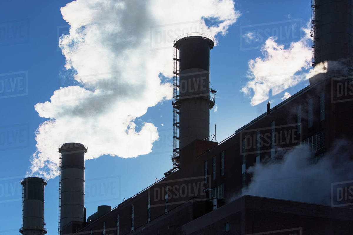 Smokestack releasing smoke - Royalty-free Stock Photo | Dissolve