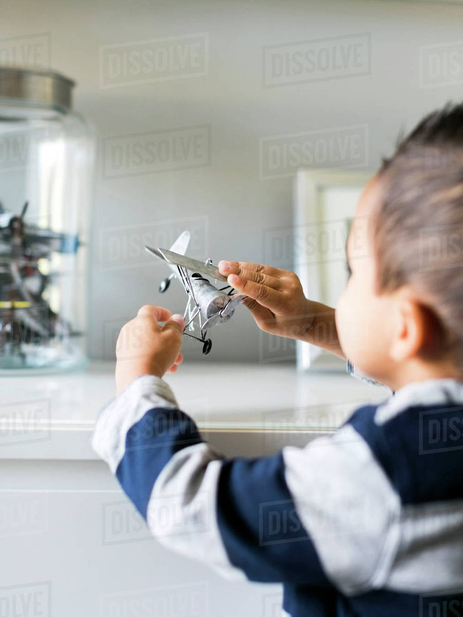 Boy (2-3) playing with model airplane - Royalty-free Stock Photo | Dissolve