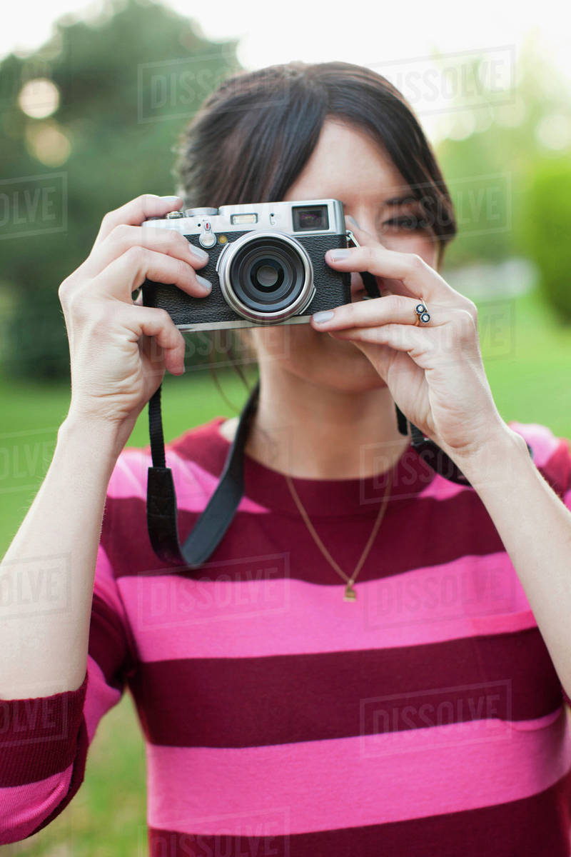 Woman using old camera - Royalty-free Stock Photo | Dissolve