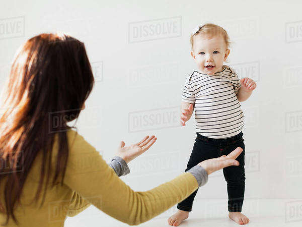 Mother raising hands towards her daughter (12-17 months) - Stock Photo ...