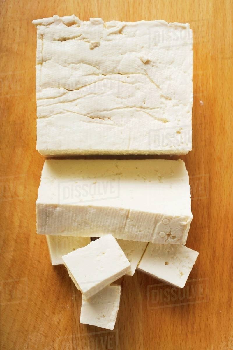 Tofu, a block, a slice and diced on wooden background - Stock Photo ...